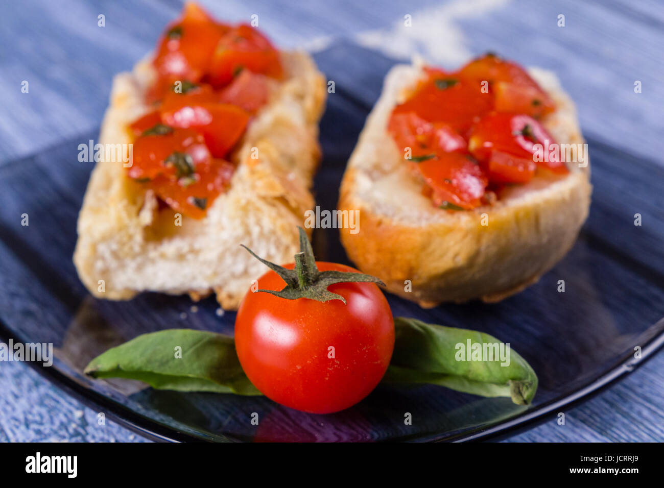 Italian bruschetta, a grilled crusty bread with tomatoes in pieces ...