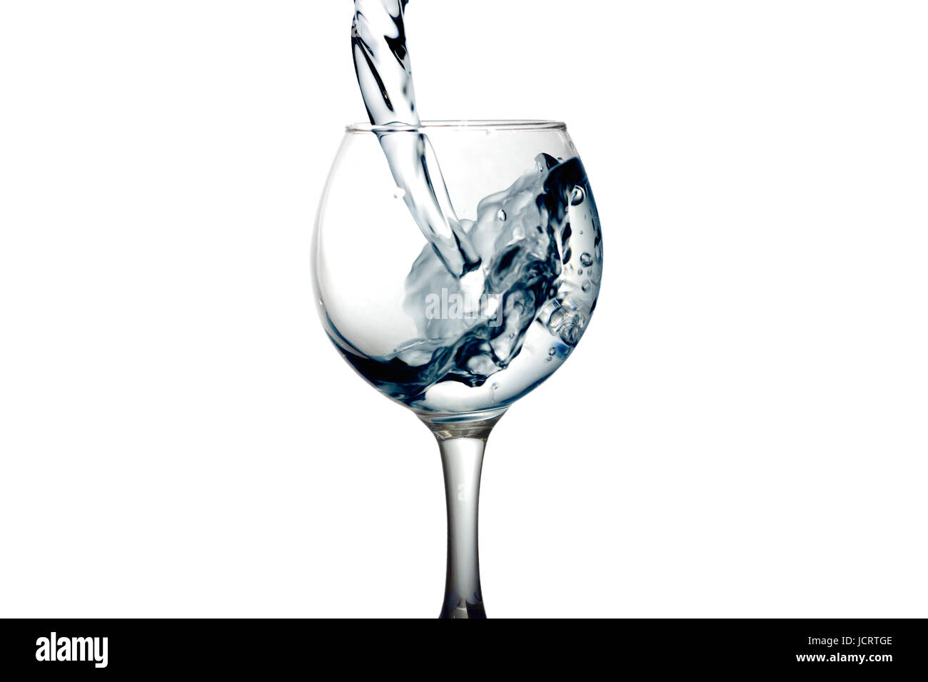 Colorless liquid, water,vodka is poured into a glass, liquid in a ...