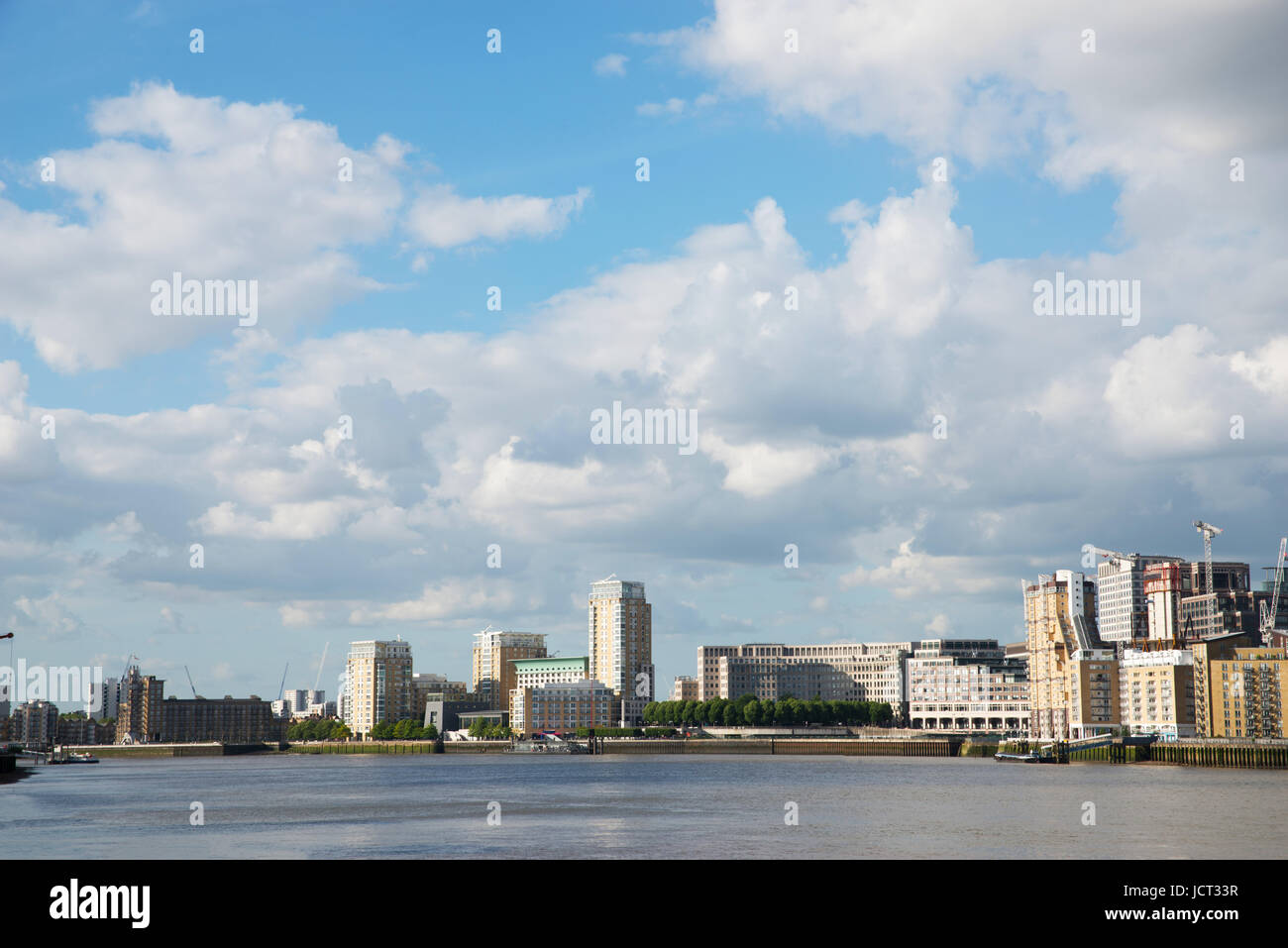 Wide river canal, city skyline, residential buildings on the other side ...