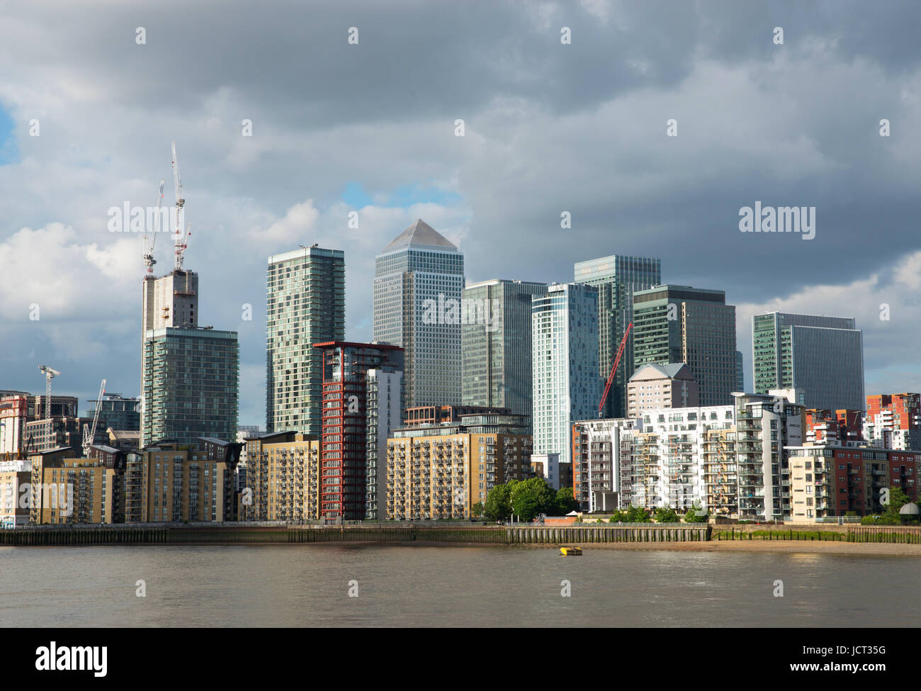 Wide river canal, city skyline, residential buildings on the other side ...