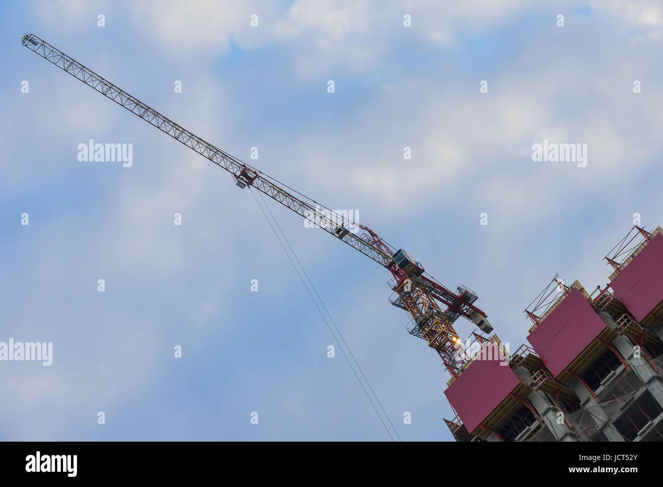 Specially diagonal image of construction tower crane next to building ...