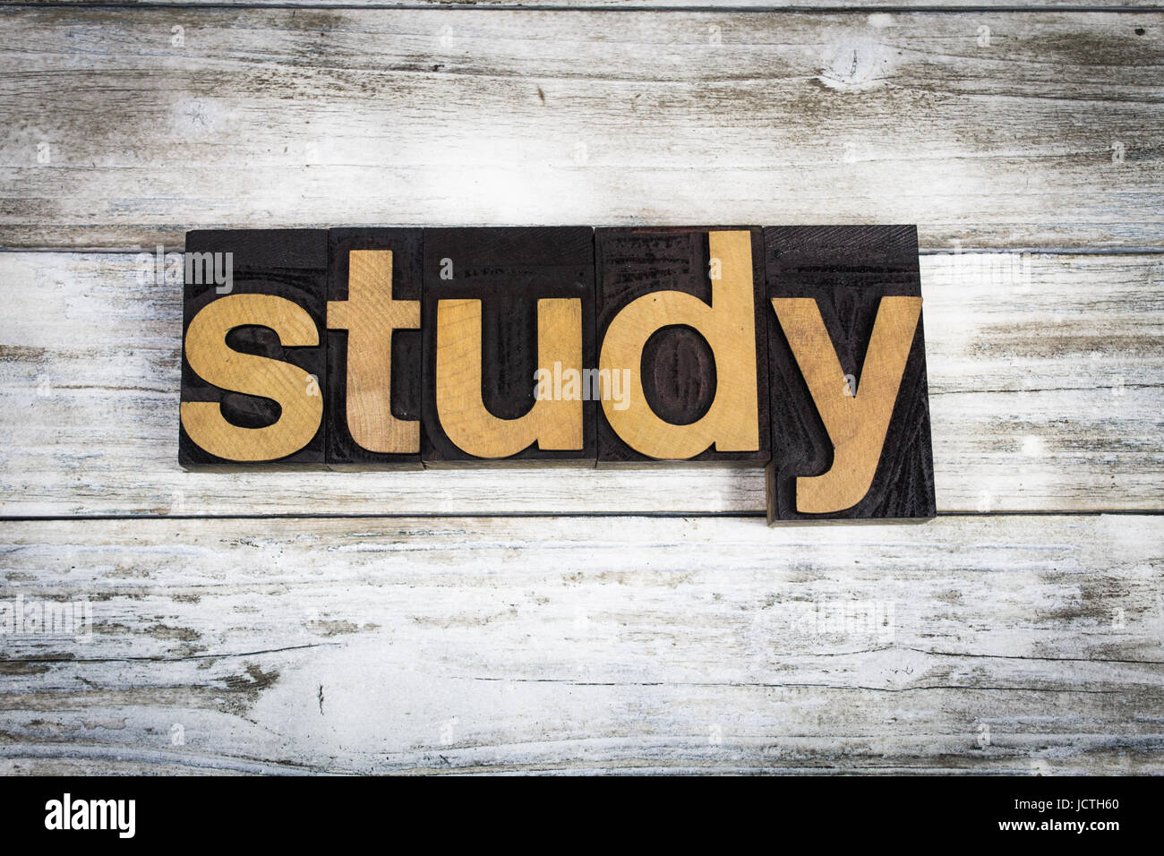 The word "study" written in wooden letterpress type on a white washed ...