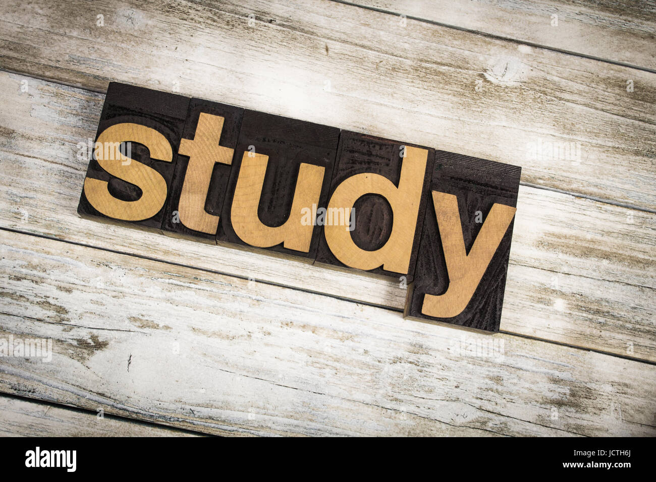 The word "study" written in wooden letterpress type on a white washed ...