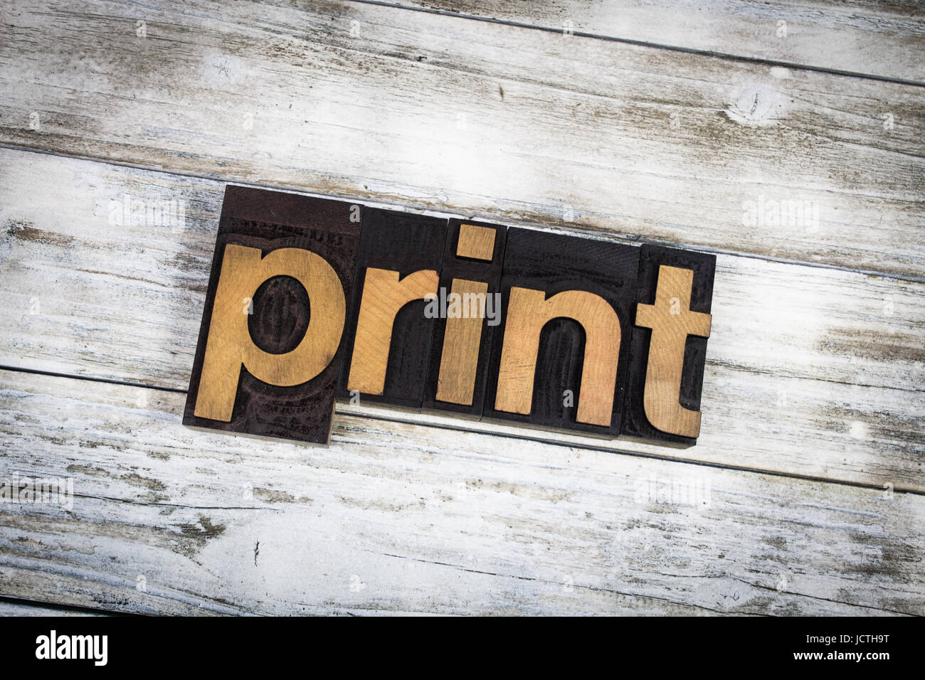 The word "print" written in wooden letterpress type on a white washed ...