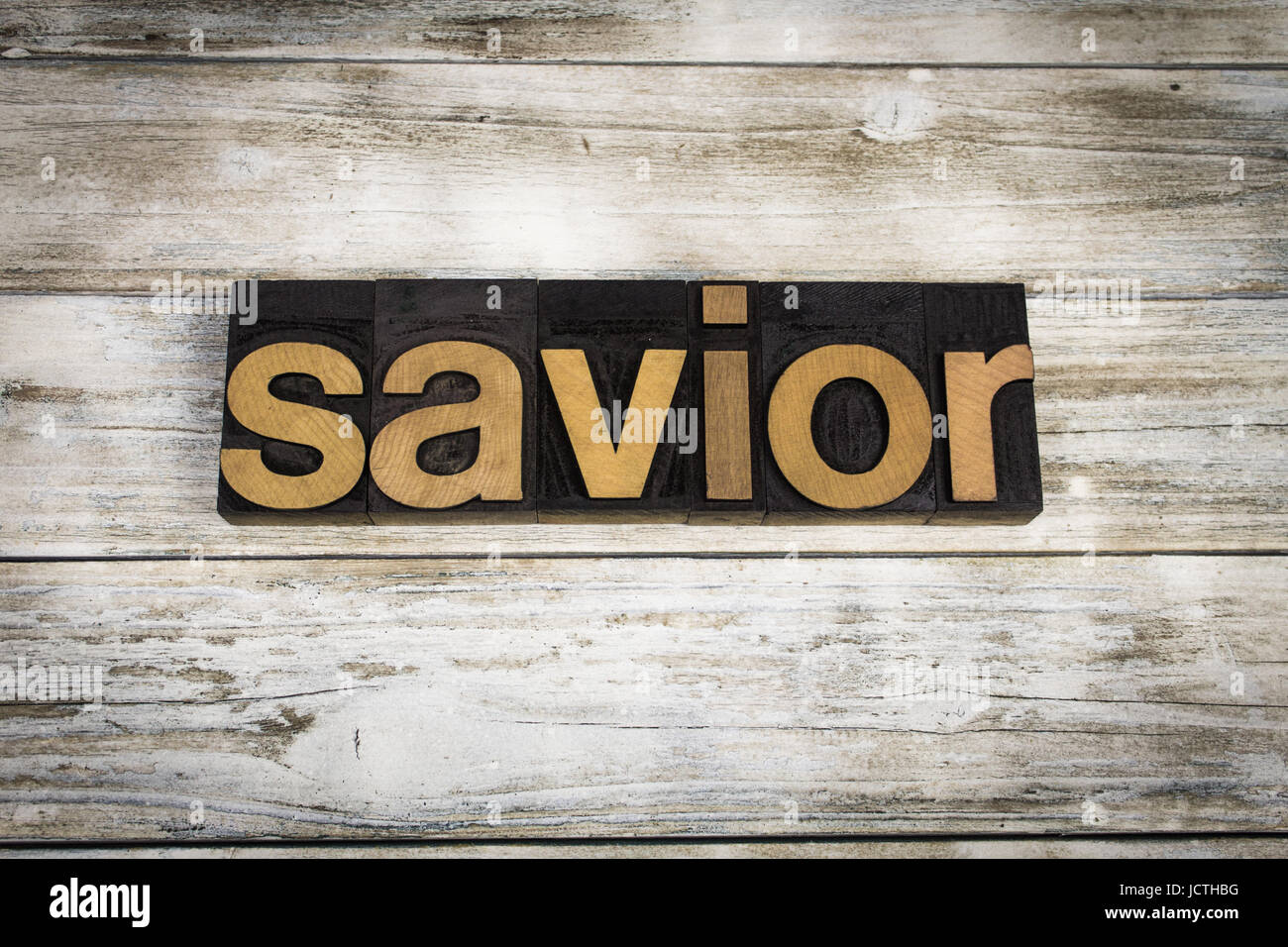The word "savior" written in wooden letterpress type on a white washed ...