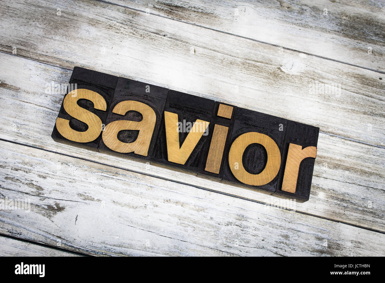 The word "savior" written in wooden letterpress type on a white washed ...