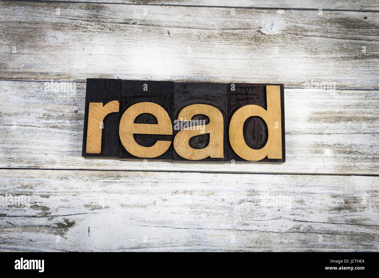 The word "read" written in wooden letterpress type on a white washed ...