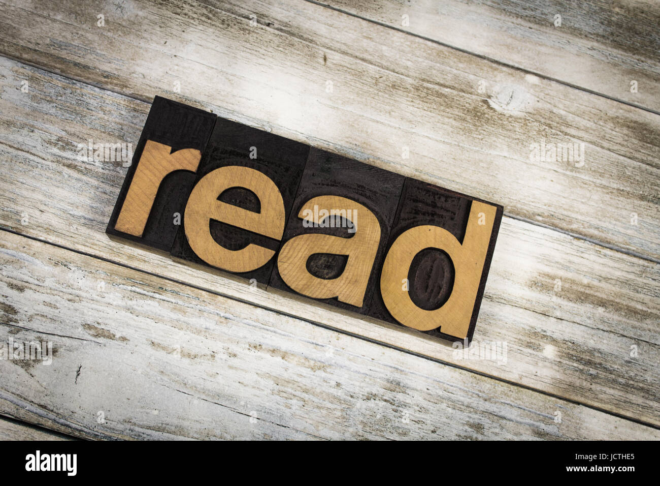The word "read" written in wooden letterpress type on a white washed ...