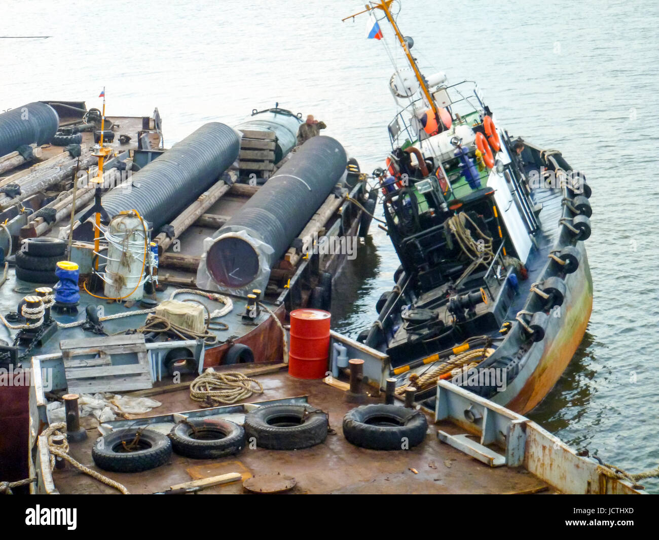 The deck lay barge. Pipes and Lifting cranes on the ship. Equipment for ...