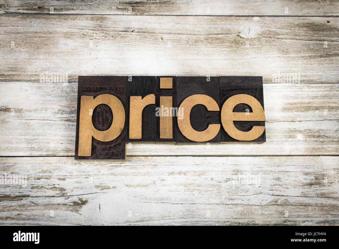 The word "price" written in wooden letterpress type on a white washed ...