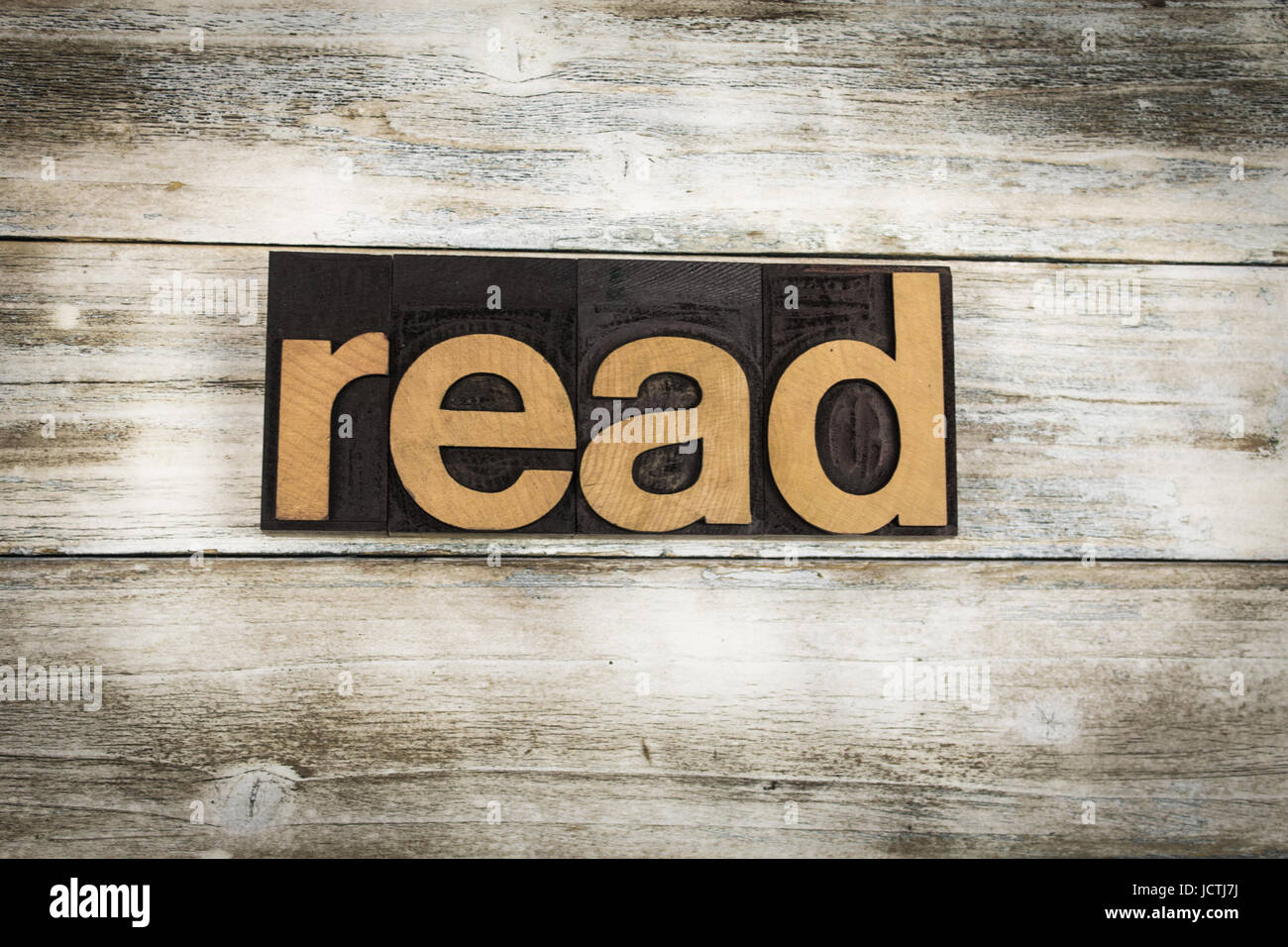 The word "read" written in wooden letterpress type on a white washed ...