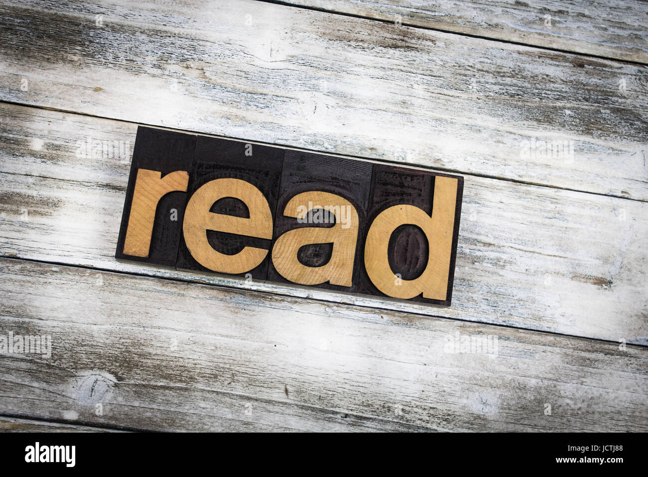 The word "read" written in wooden letterpress type on a white washed ...