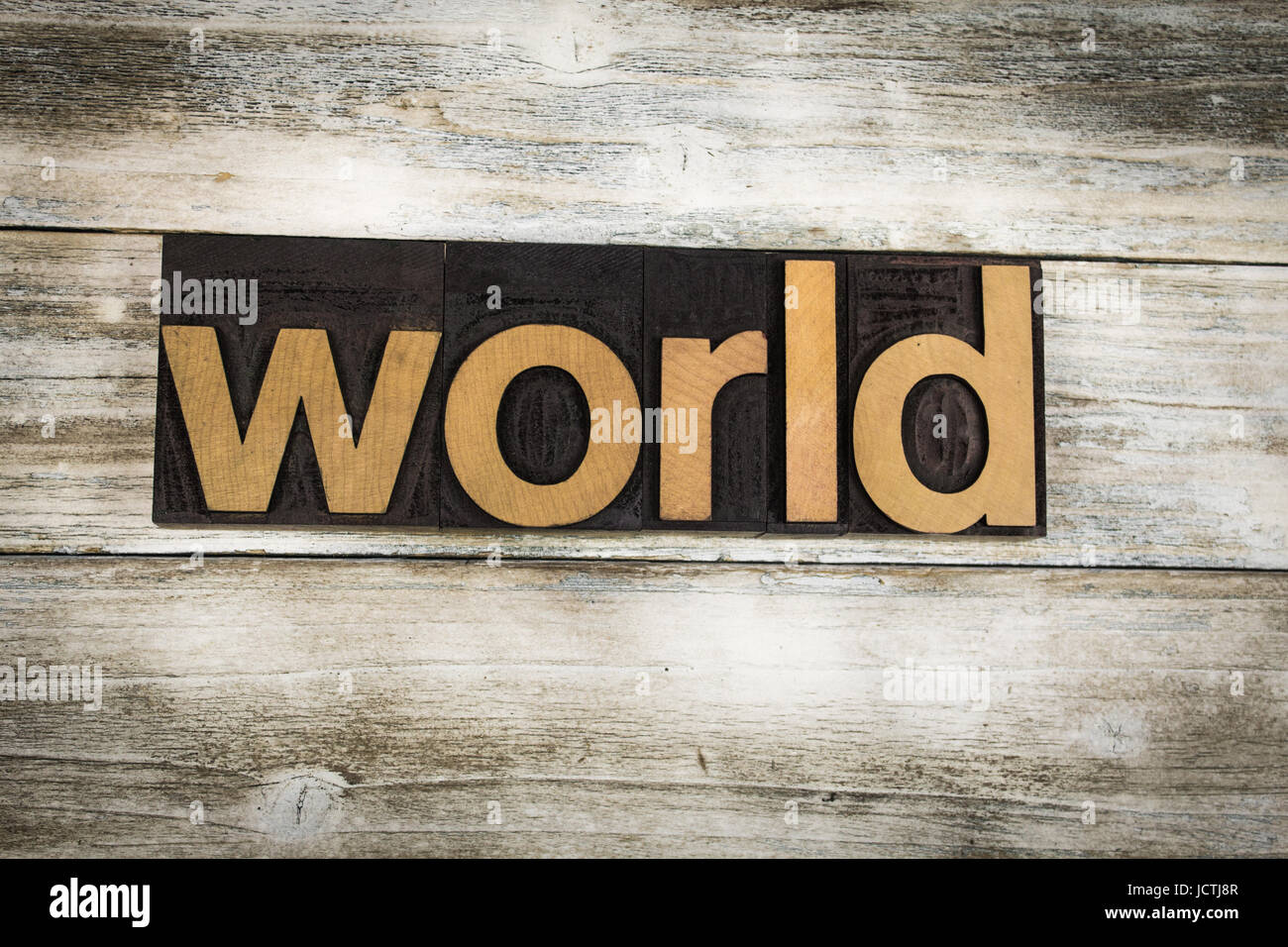 The word "world" written in wooden letterpress type on a white washed ...
