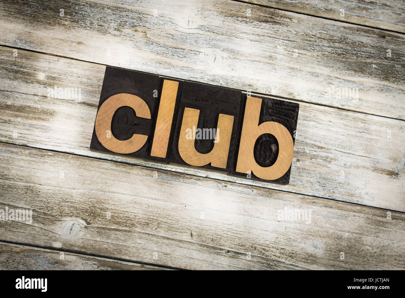 The word "club" written in wooden letterpress type on a white washed ...
