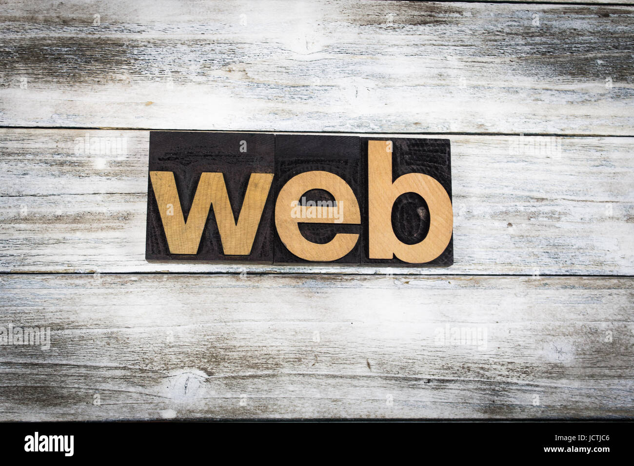 The word "web" written in wooden letterpress type on a white washed old ...