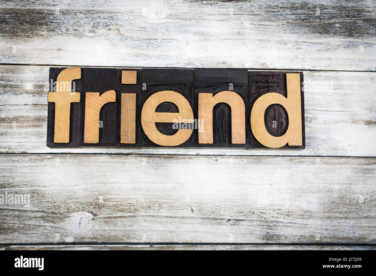The word "friend" written in wooden letterpress type on a white washed ...