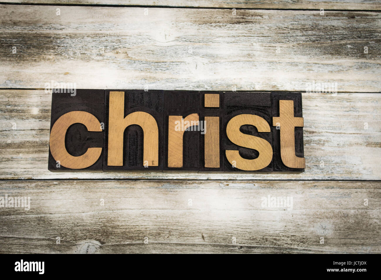 The word "christ" written in wooden letterpress type on a white washed ...