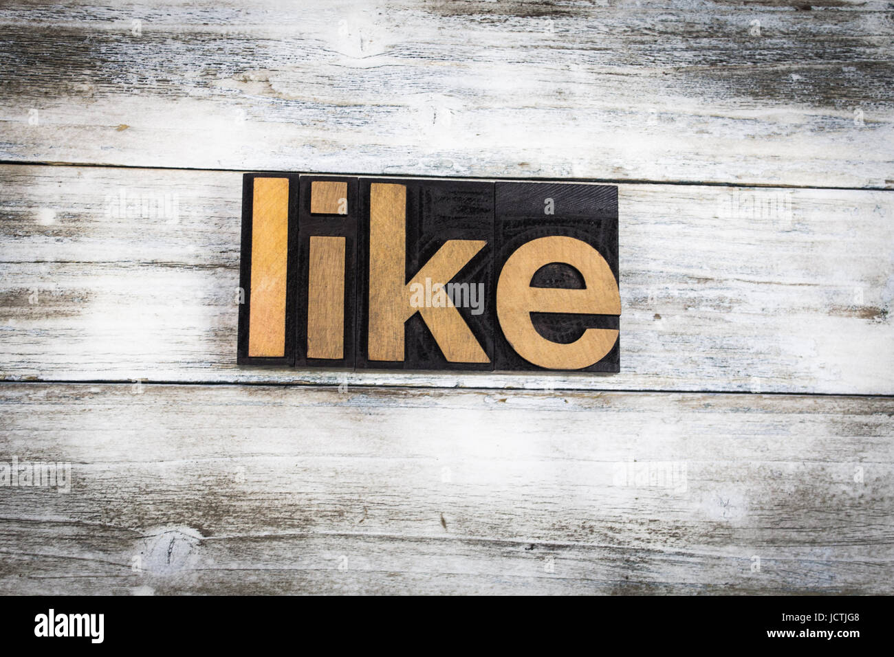 The word "like" written in wooden letterpress type on a white washed ...