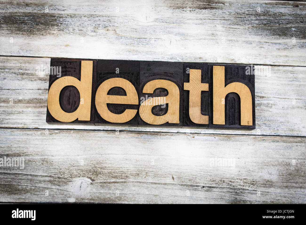 The word "death" written in wooden letterpress type on a white washed ...