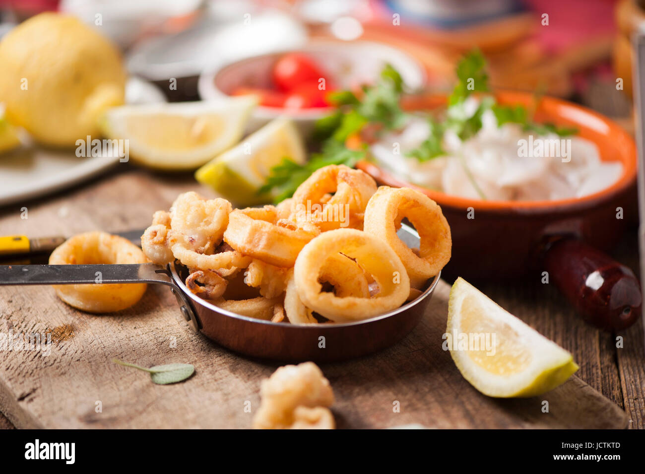 crispy calamari rings on wooden table Stock Photo - Alamy