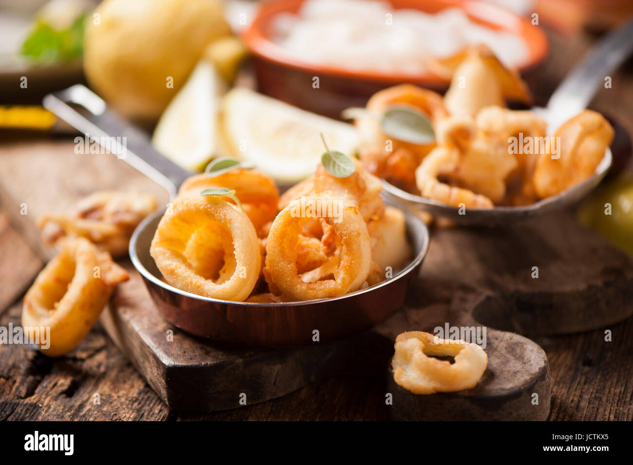 crispy calamari rings on wooden table Stock Photo - Alamy