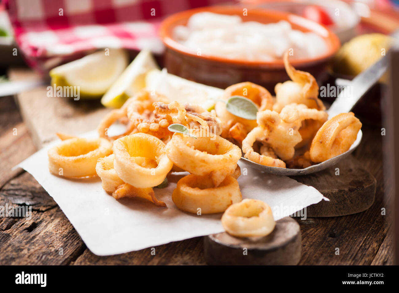 crispy calamari rings on wooden table Stock Photo - Alamy