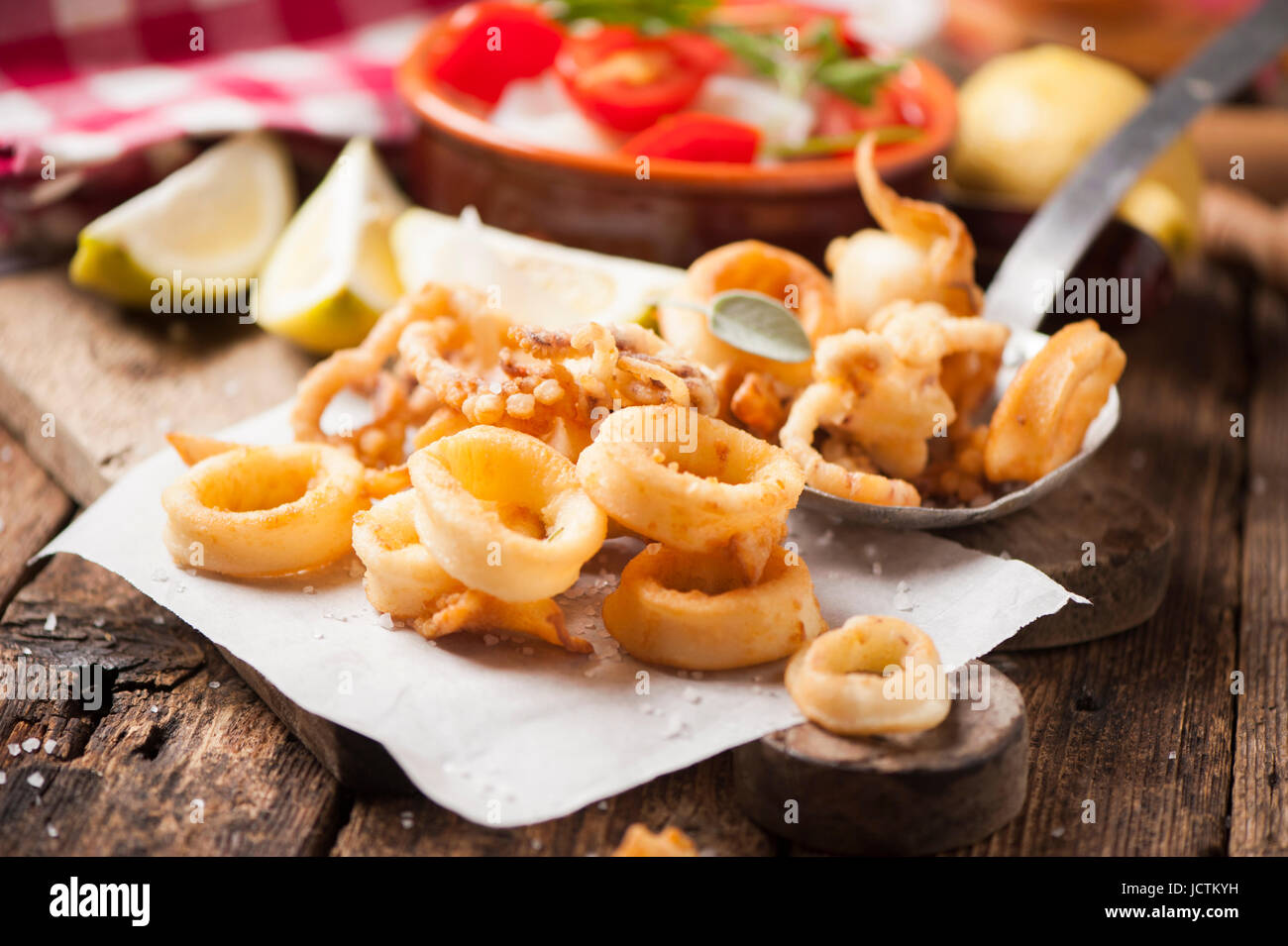 crispy calamari rings on wooden table Stock Photo - Alamy