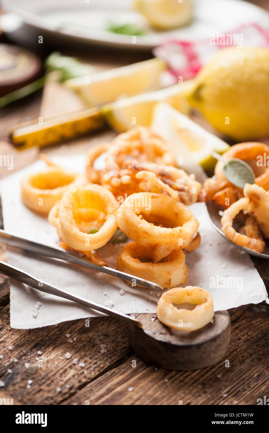 crispy calamari rings on wooden table Stock Photo - Alamy