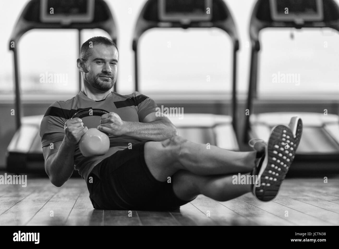 Young Man Doing Exercise With Kettle Bell In The Gym Stock Photo - Alamy