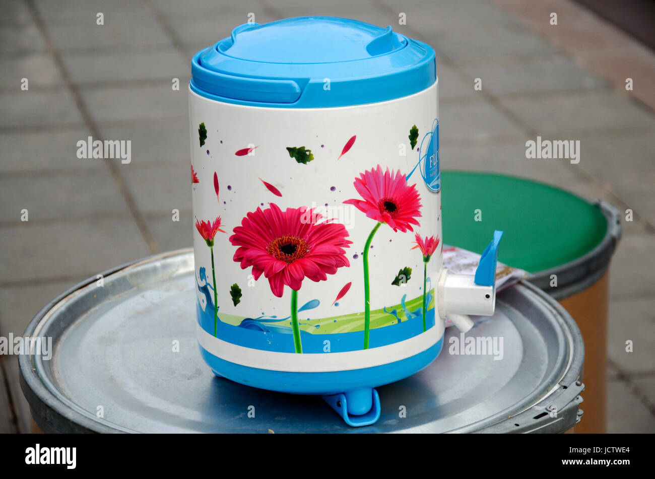 Plastic cooler cold water tank on table at outdoor Stock Photo - Alamy