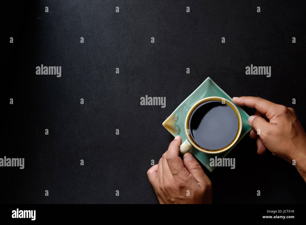 Top view with copyspace of Man hands holding Coffee on kitchen table ...