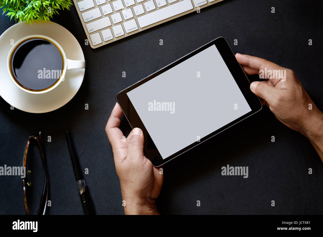 Modern dark surface office desk table with computer, Tablet with blank ...