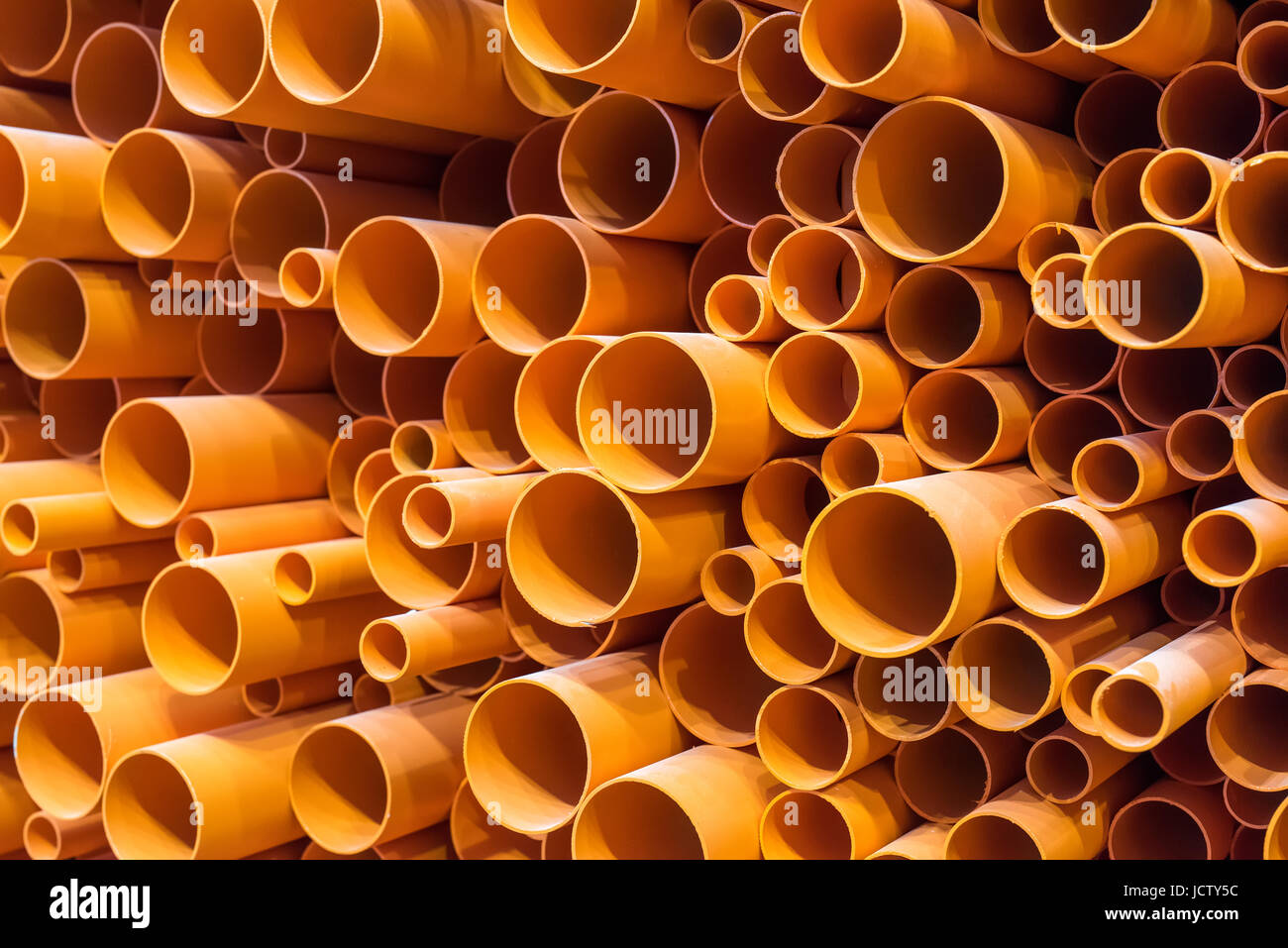 PVC pipes stacked in construction site Stock Photo - Alamy