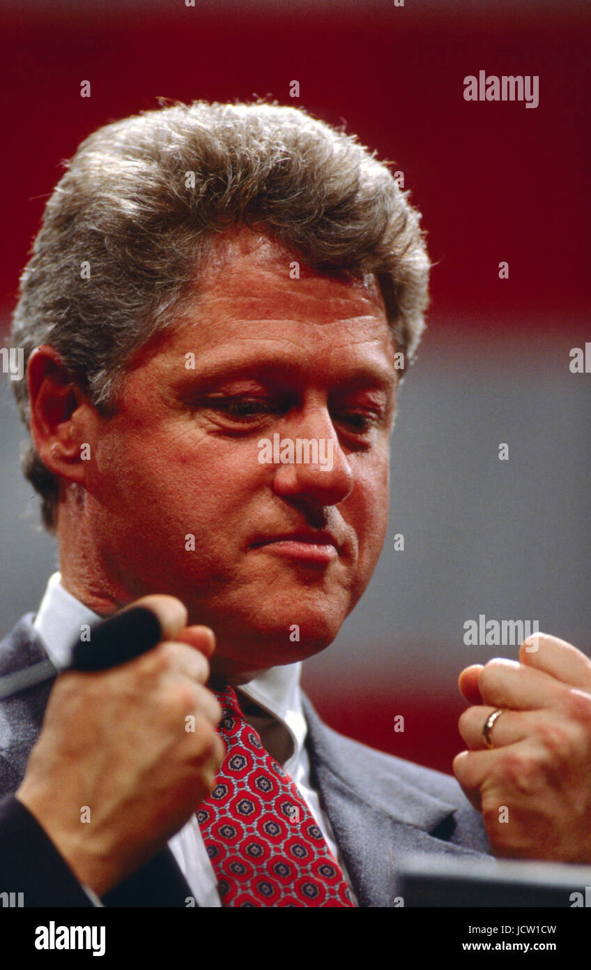 President Bill Clinton while speaking. A large American flag hangs ...