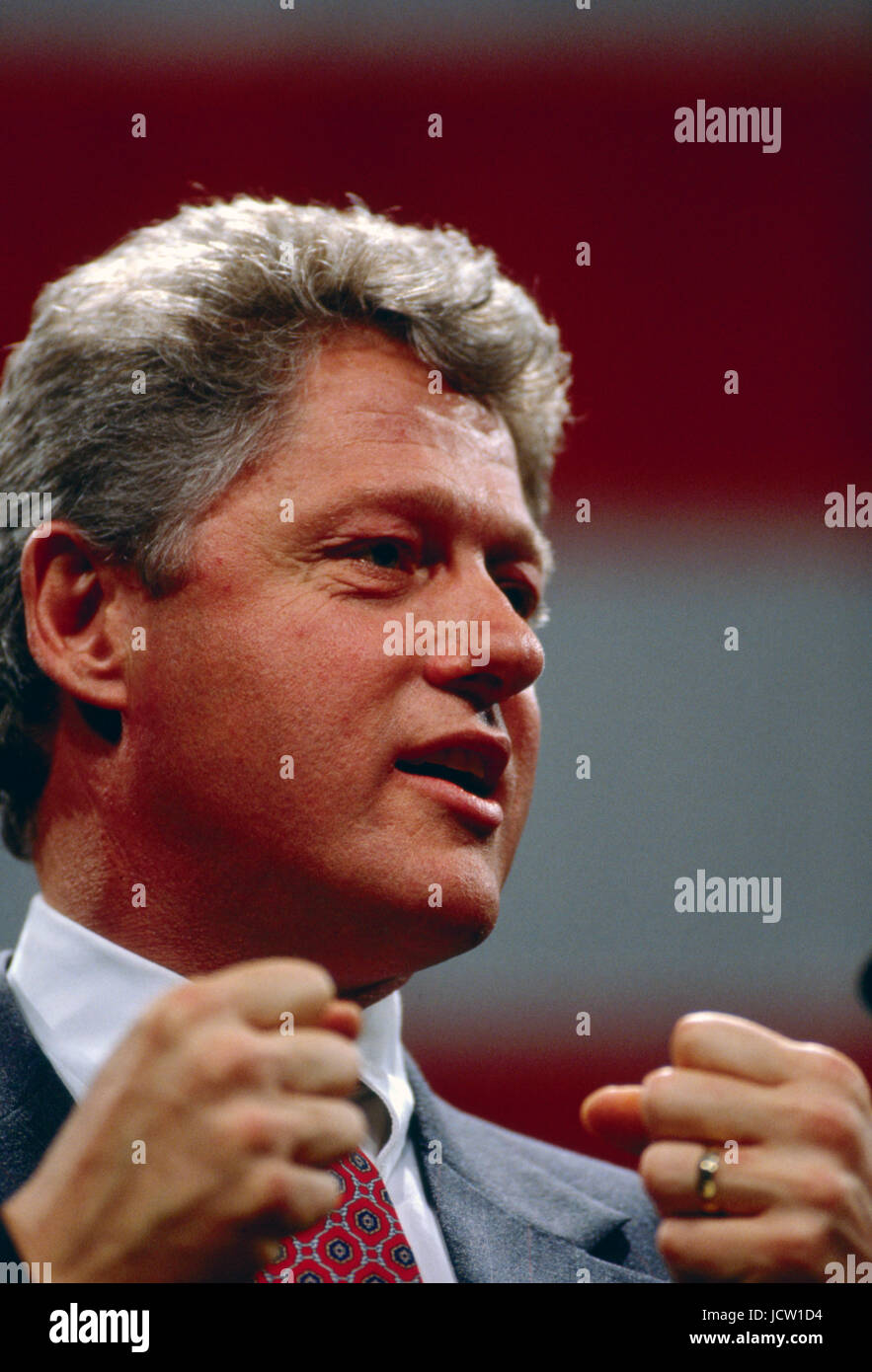 President Bill Clinton while speaking. A large American flag hangs ...