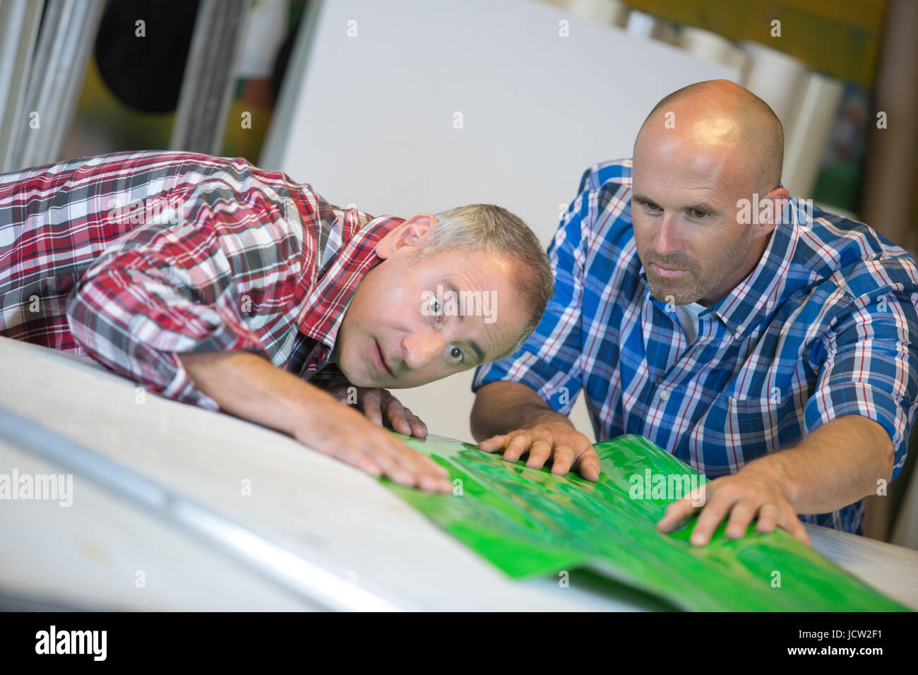 men placing mat Stock Photo - Alamy