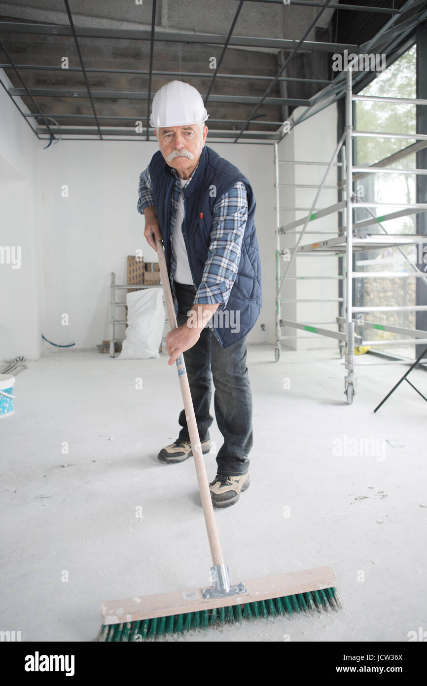 male worker cleaning warehouse with mop Stock Photo - Alamy