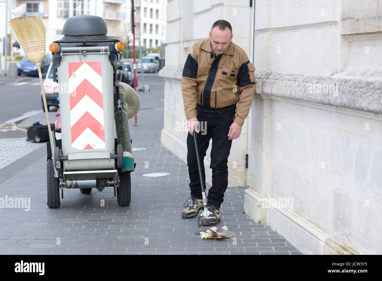 working man standing near dustbin on street Stock Photo - Alamy