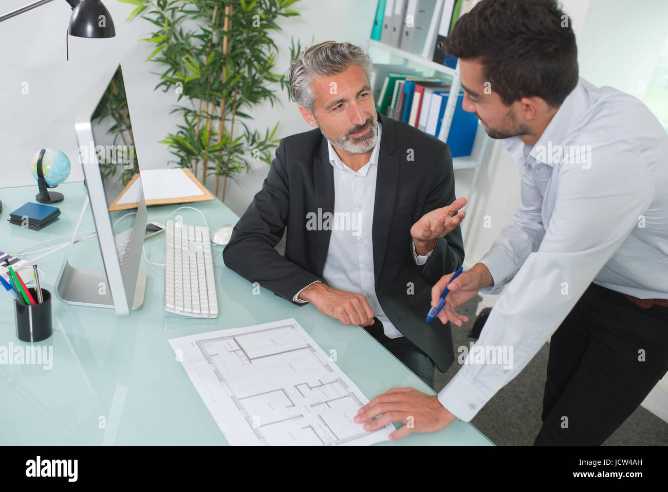 architects working on a construction plans together Stock Photo - Alamy