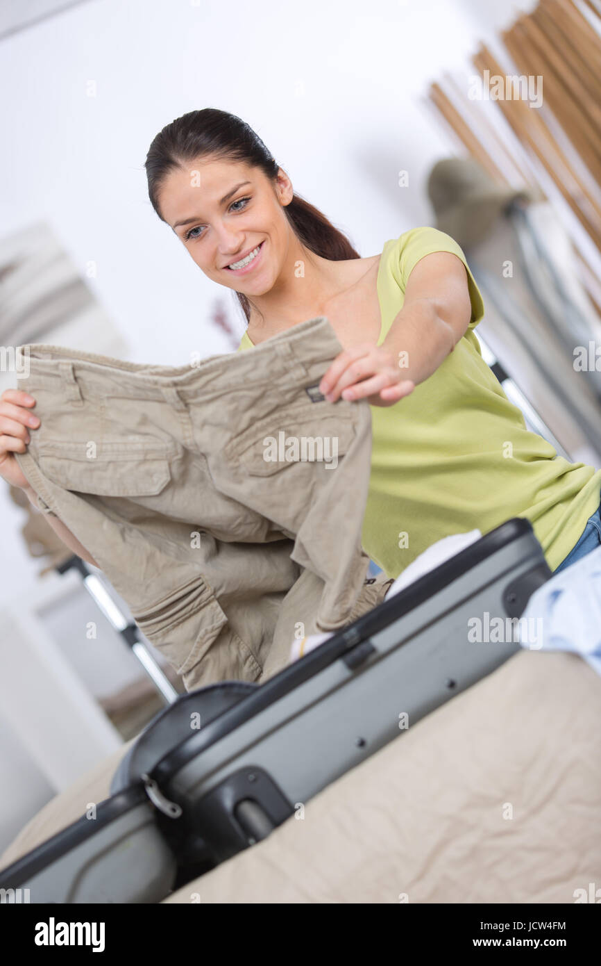 woman packing a luggage for a new journey Stock Photo - Alamy