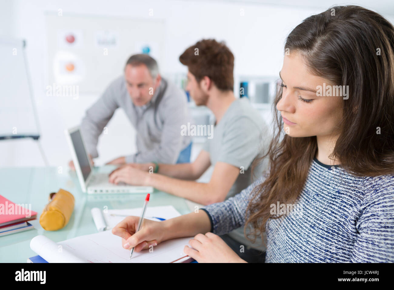 students are sitting in classroom and taking notes Stock Photo - Alamy