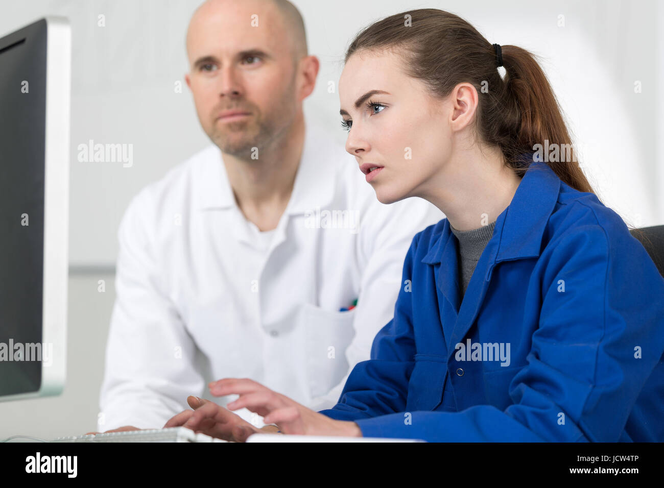 instructor helping student with work project Stock Photo - Alamy