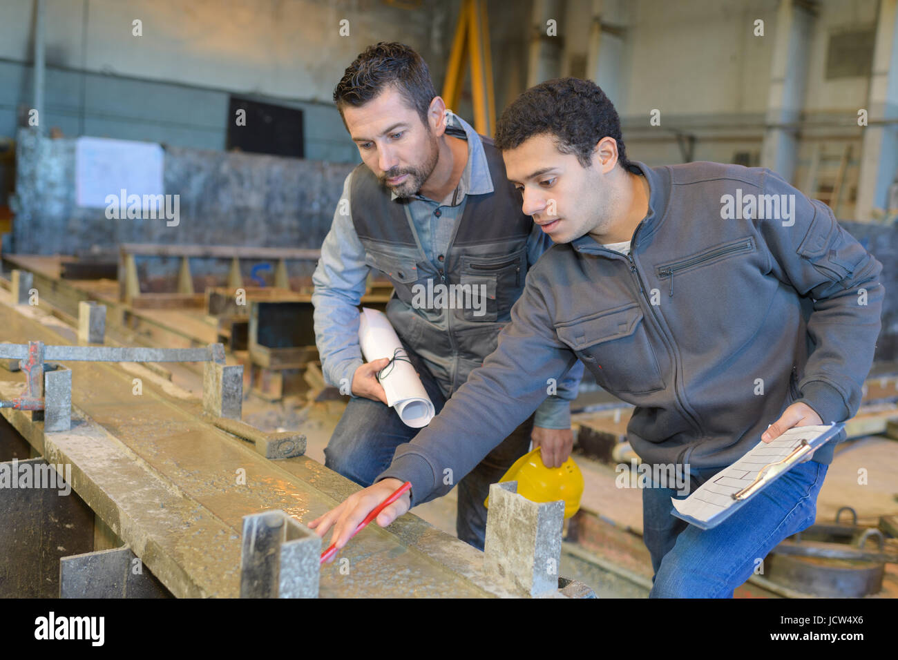 team of engineers having discussion in factory Stock Photo - Alamy