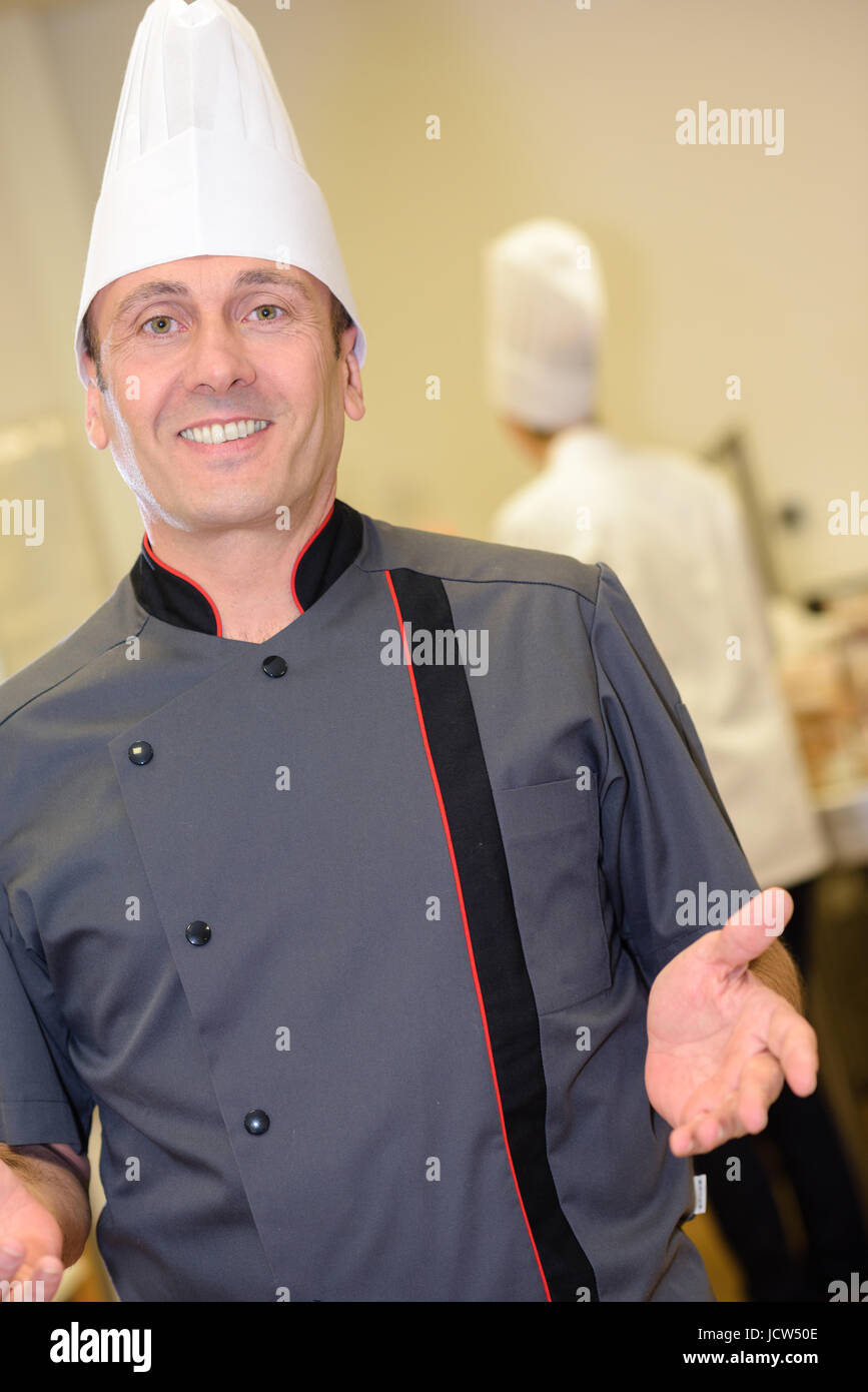 smiling happy chef in commercial kitchen Stock Photo - Alamy