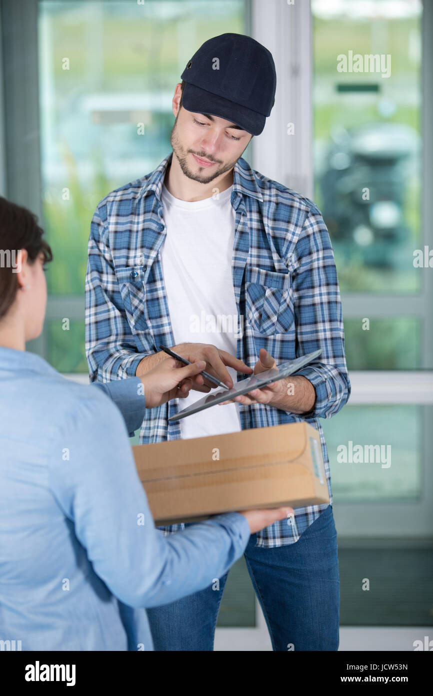 woman receiving parcel from delivery man Stock Photo - Alamy