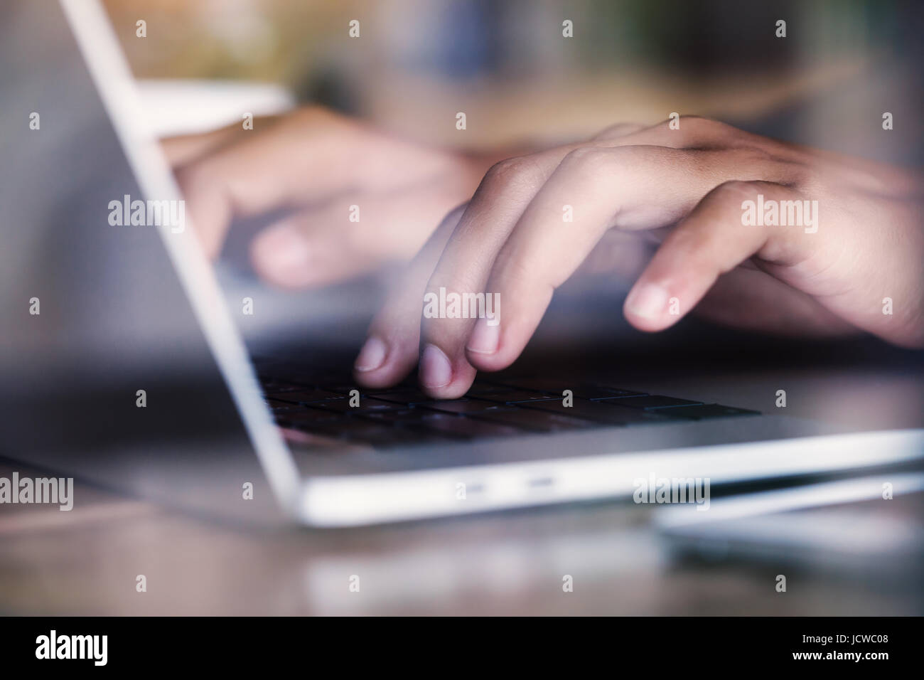 close-up finger typing on laptop keyboard see through glass Stock Photo ...