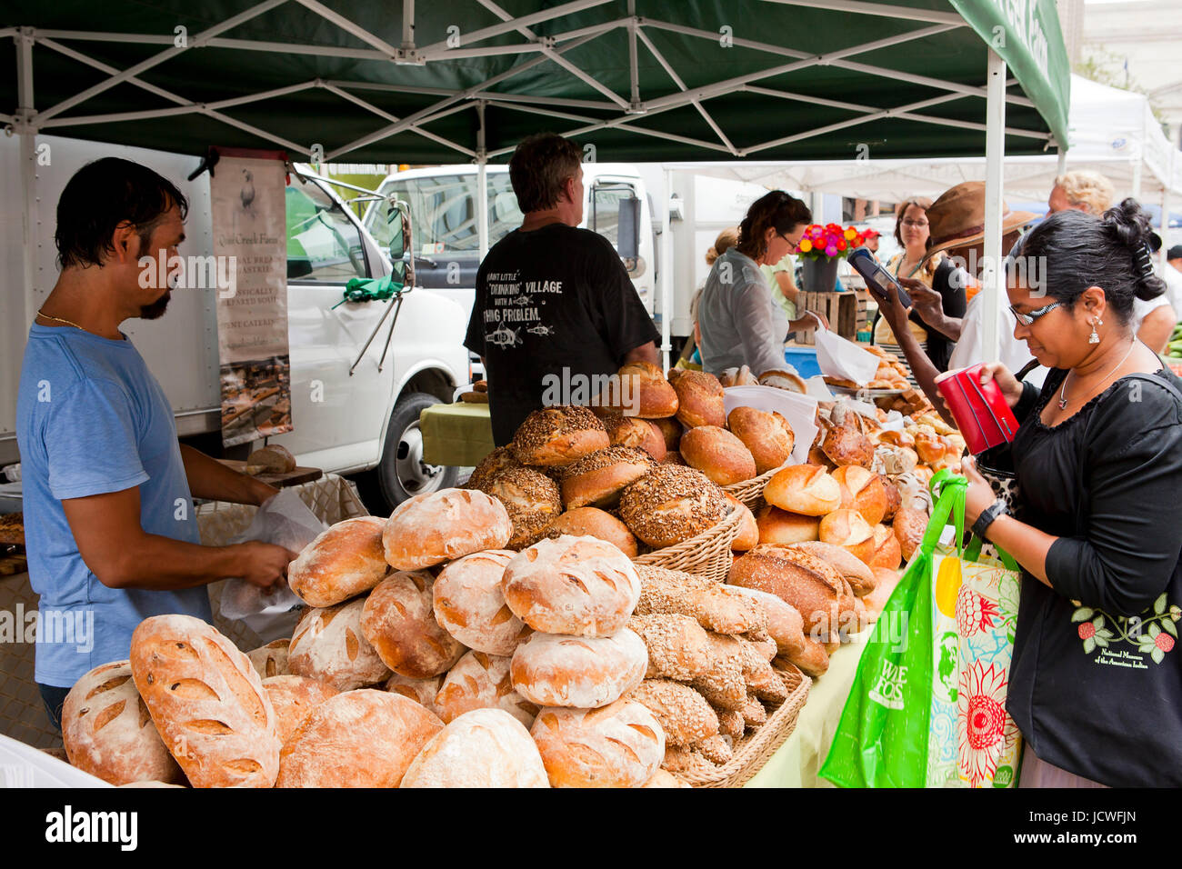 Woman buying loaves of bread at farmers market - USA Stock Photo - Alamy