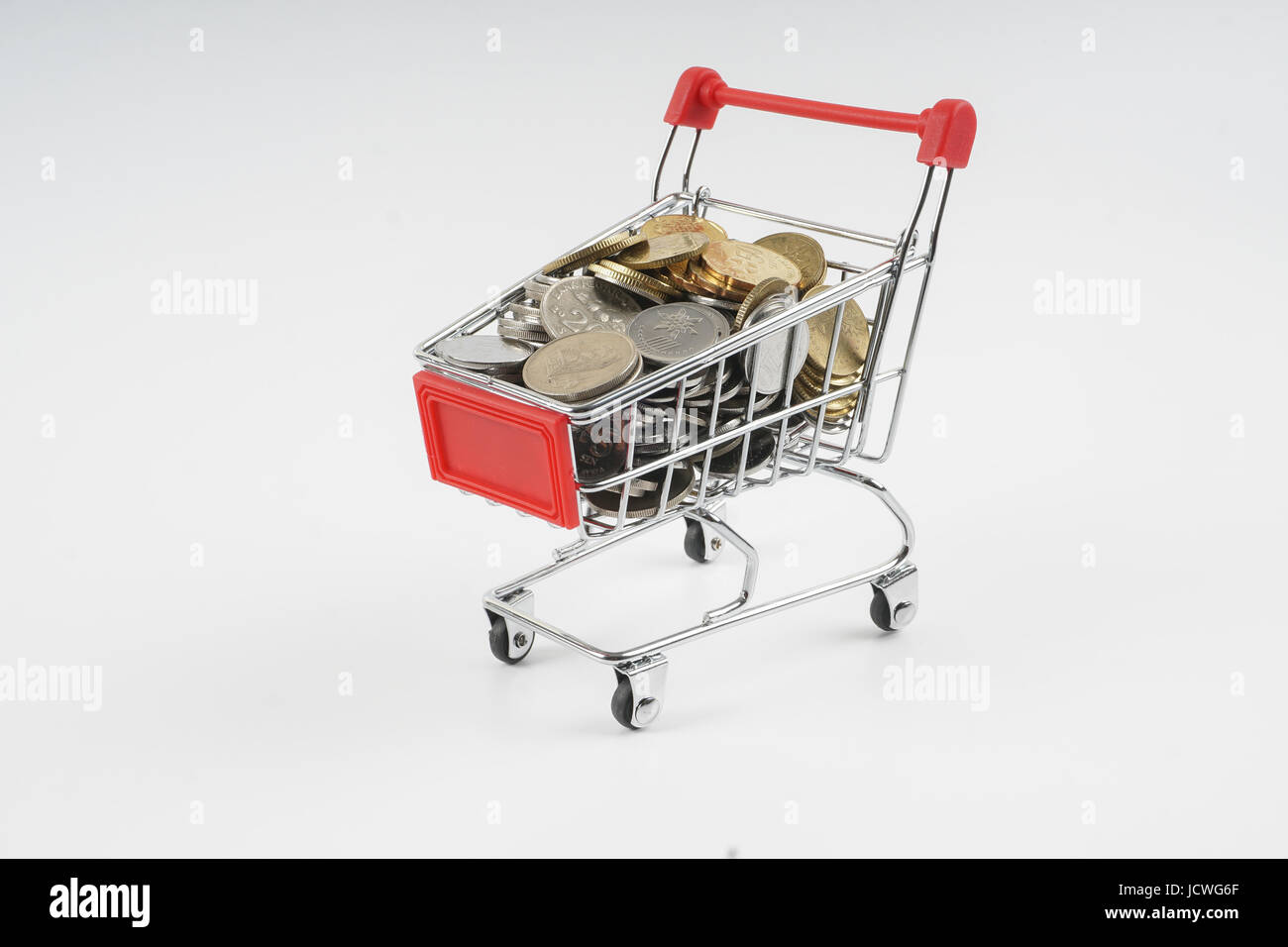 Trolley and coins isolated on white. Sales concept Stock Photo - Alamy