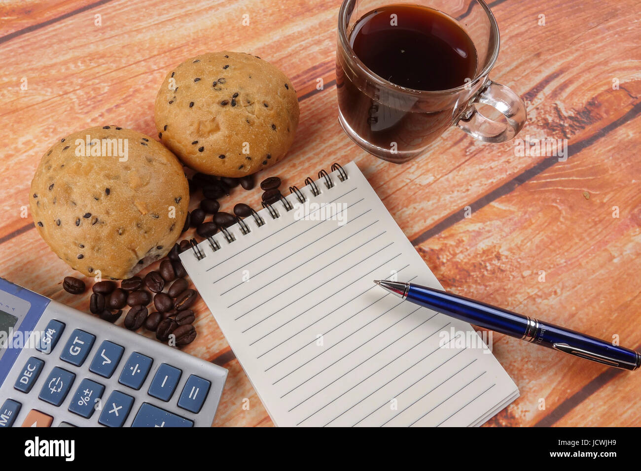 Morning breakfast concept with coffee,bun, post it notes on wooden ...