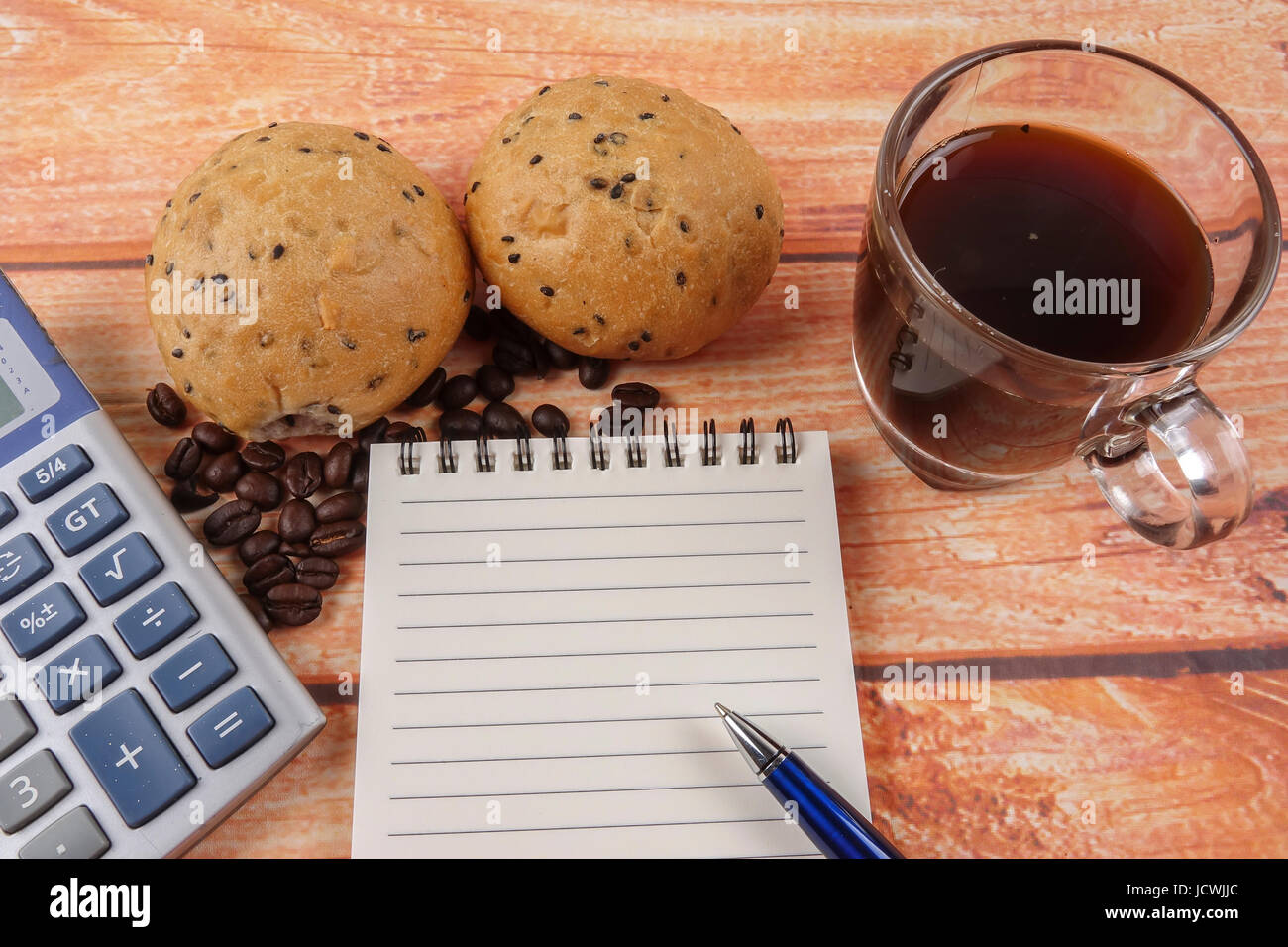 Morning breakfast concept with coffee,bun, post it notes on wooden ...